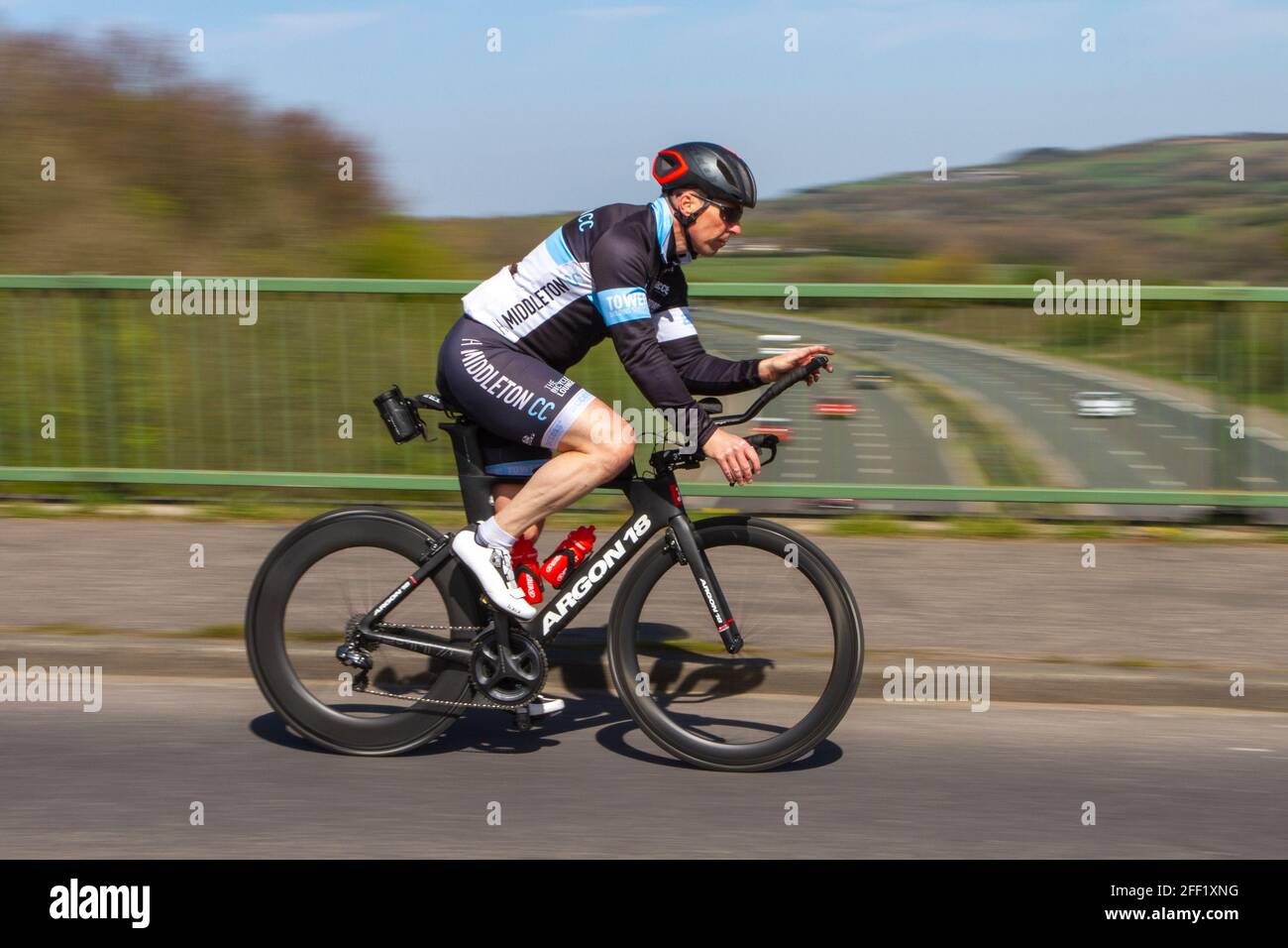 Male cyclist riding Argon 18 sports road bike, blurred, low shutter ...