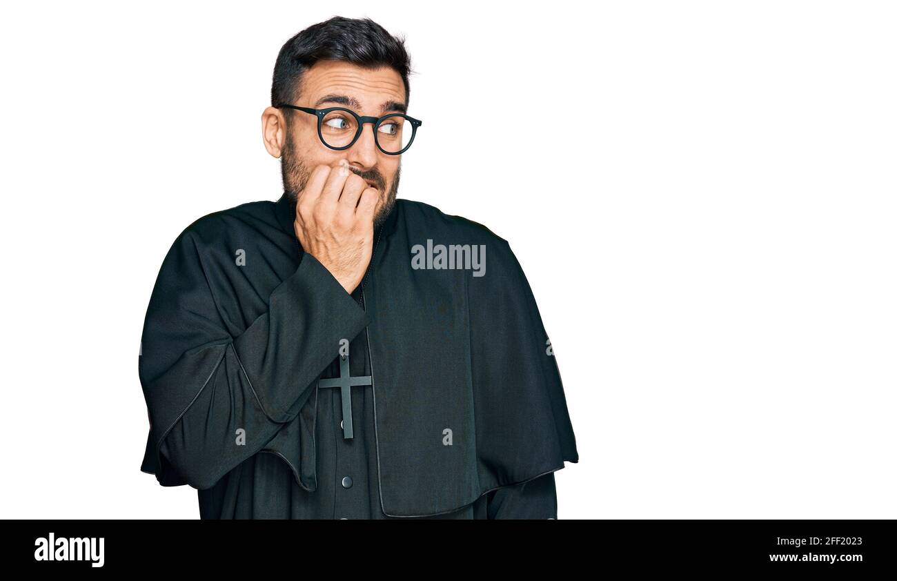 Young hispanic man wearing priest uniform looking stressed and nervous ...
