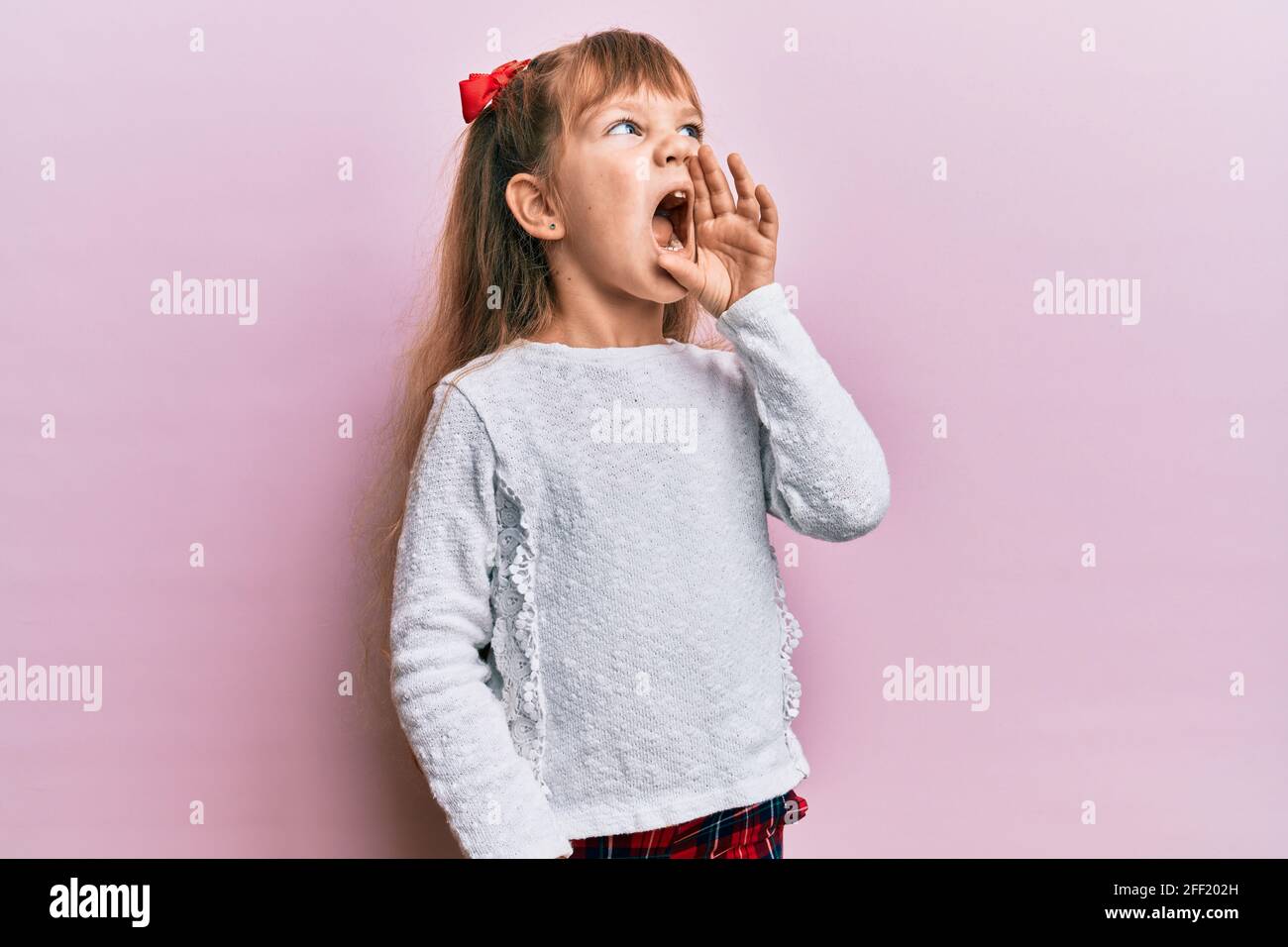 Little caucasian girl kid wearing casual clothes shouting and screaming ...