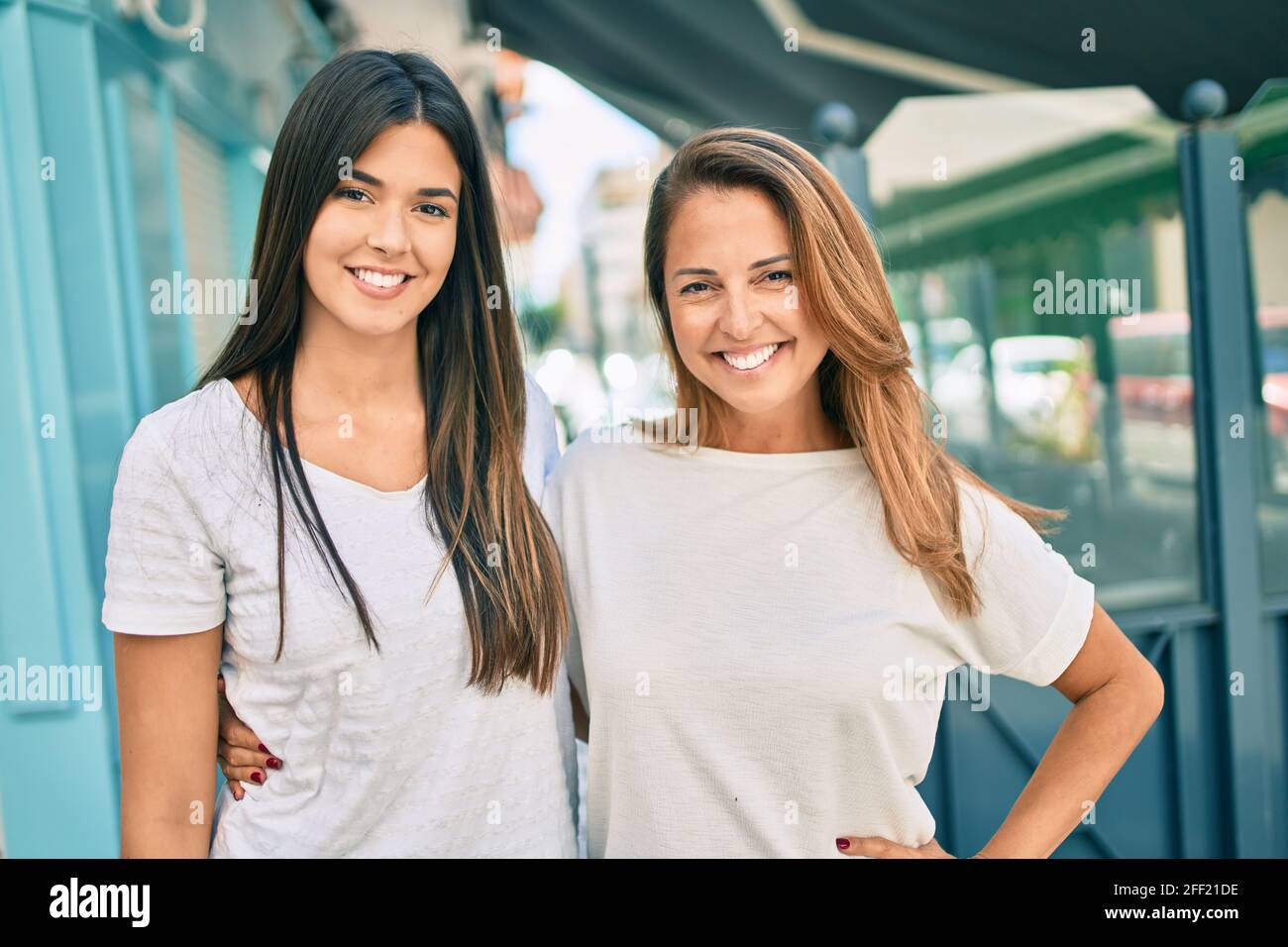 Beautiful hispanic mother and daughter smiling happy standing at the ...