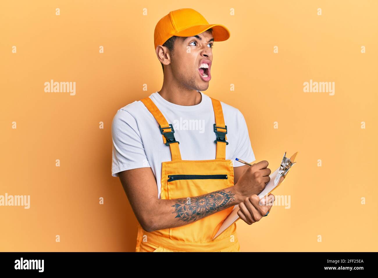 Young handsome african american man wearing courier uniform holding ...