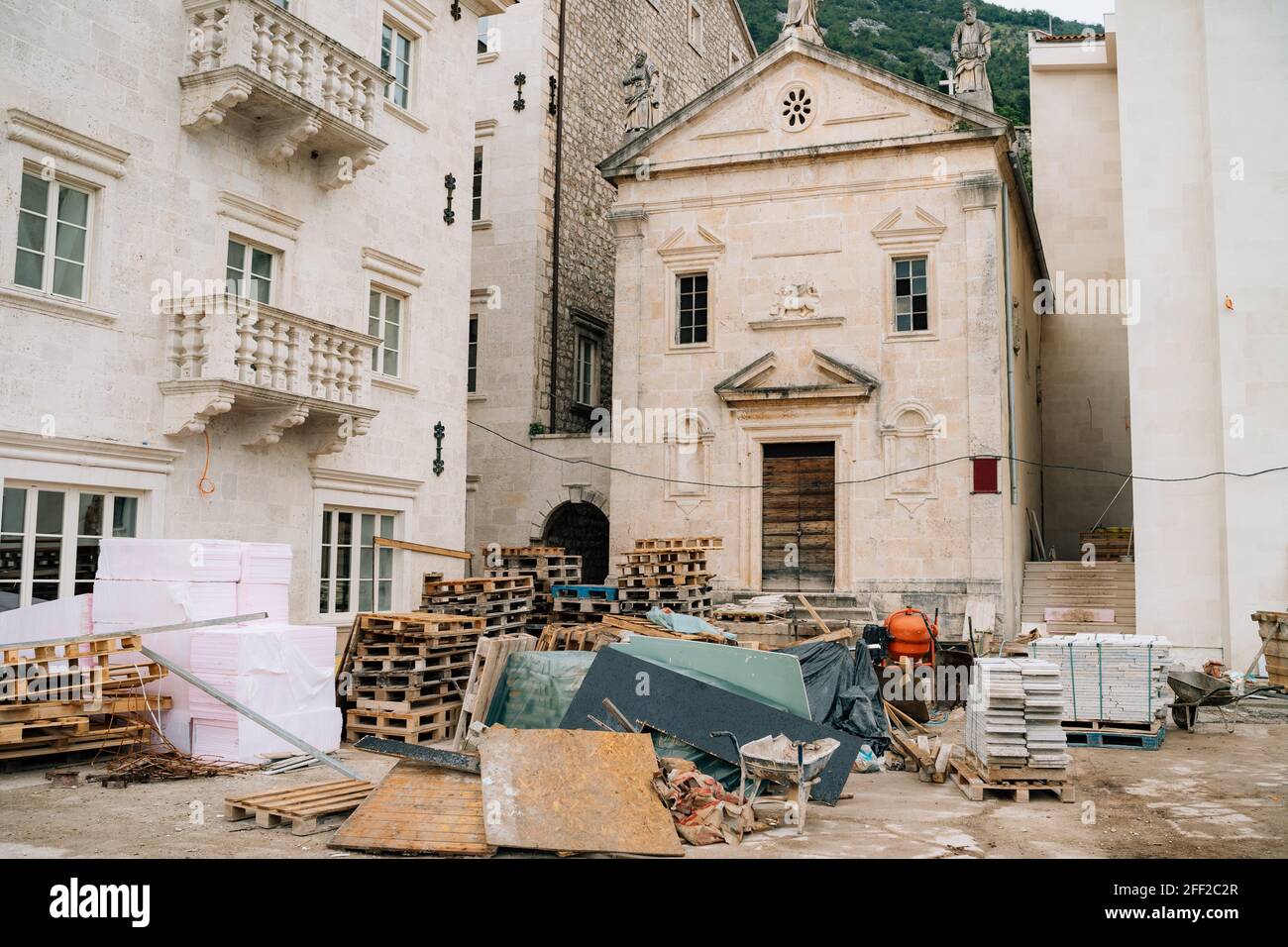 Repair work near the temple. Building materials lie on pallets at a ...