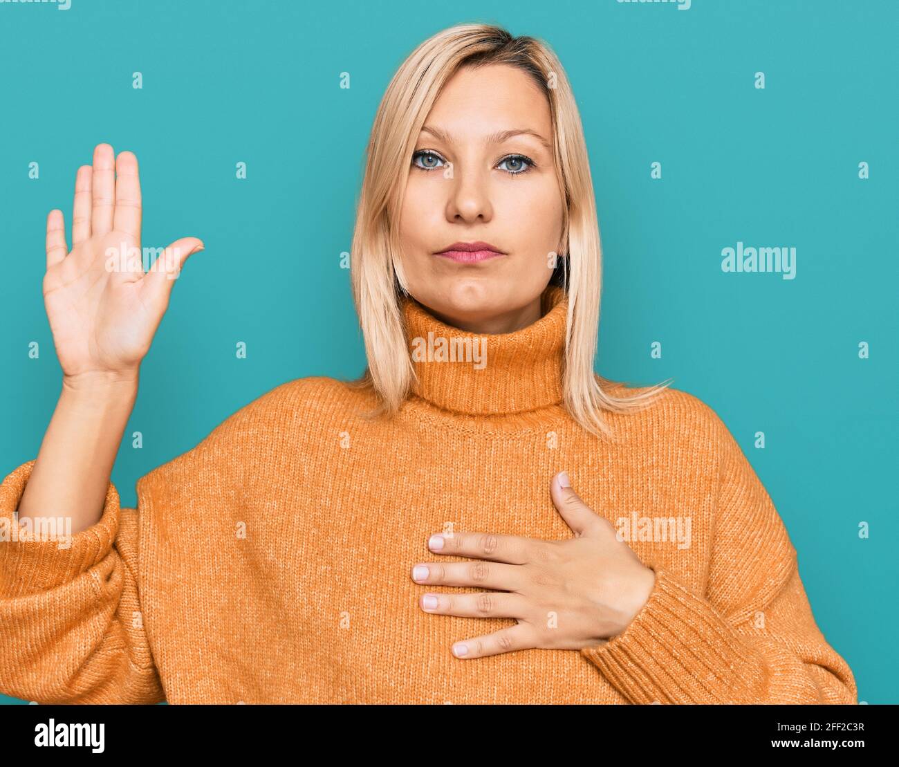 Middle age caucasian woman wearing casual winter sweater swearing with ...