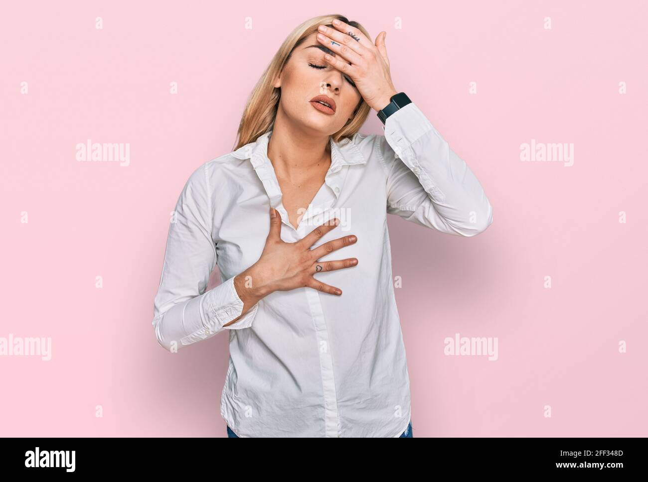 Young caucasian woman wearing casual clothes touching forehead for ...
