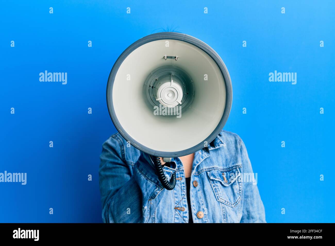 Young plus size woman shouting using megaphone Stock Photo - Alamy