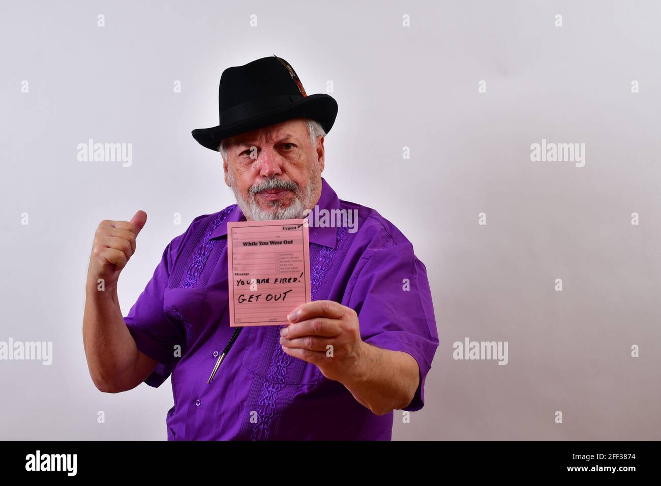 Rude boss is showing an employee the pink slip that he or she is fired ...