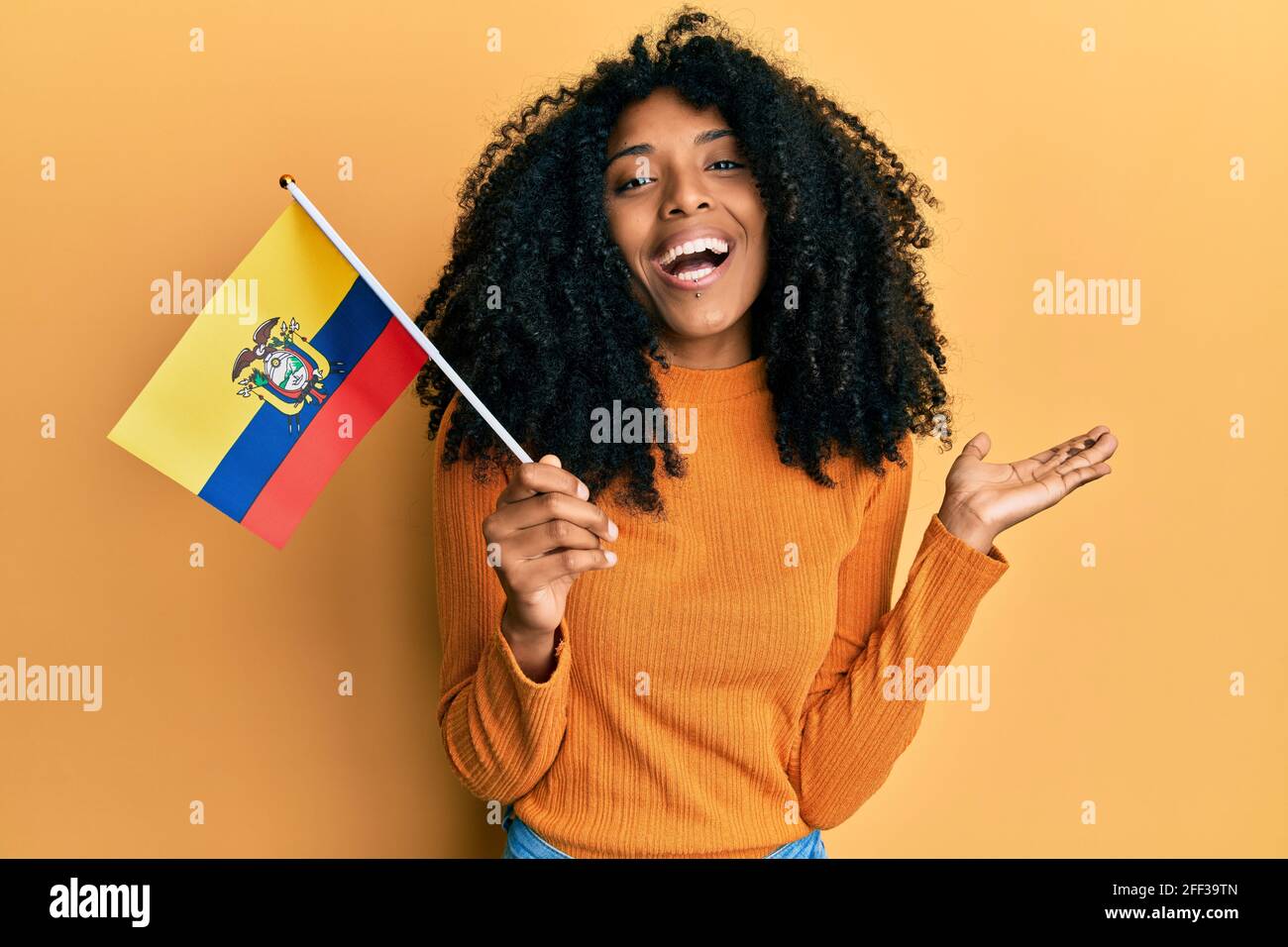 African american woman with afro hair holding ecuador flag celebrating ...