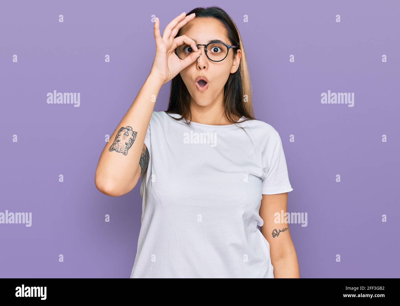 Young hispanic woman wearing casual white t shirt doing ok gesture ...