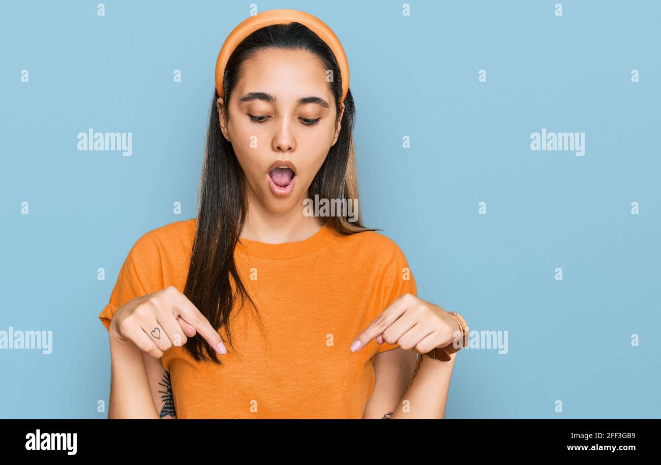 Young Hispanic Woman Wearing Casual Clothes Pointing Down With Fingers