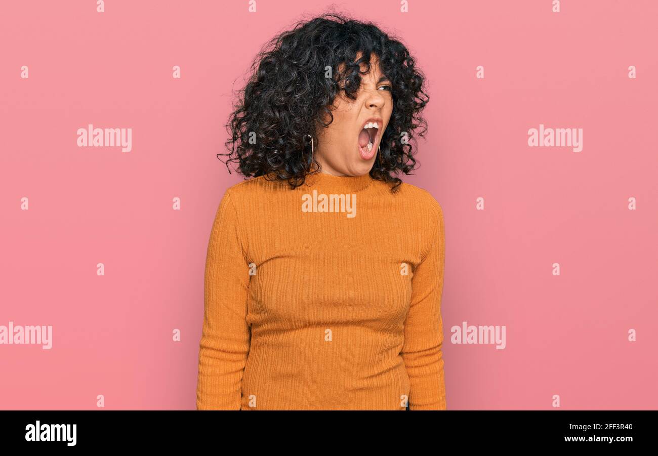 Young hispanic woman wearing casual clothes angry and mad screaming ...