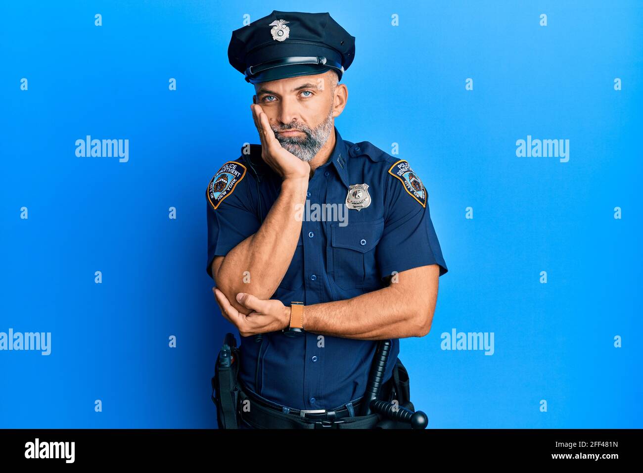 Middle age handsome man wearing police uniform thinking looking tired ...