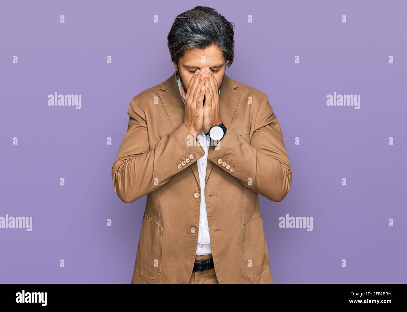 Young hispanic man wearing business clothes with sad expression ...