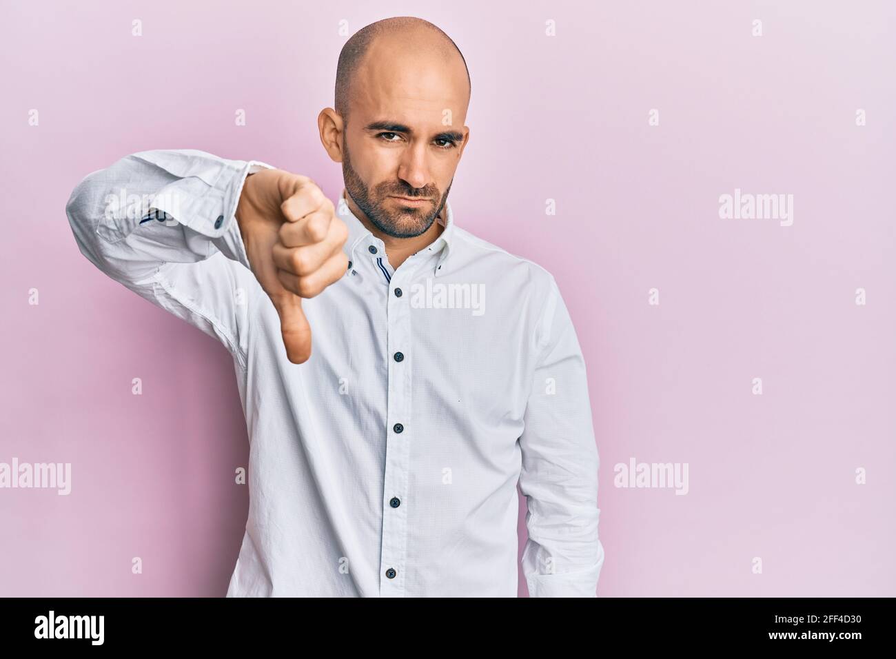 Young hispanic man wearing casual clothes looking unhappy and angry ...