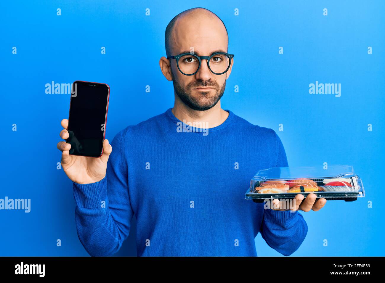 Young Hispanic Man Holding Take Away Food Showing Smartphone Screen