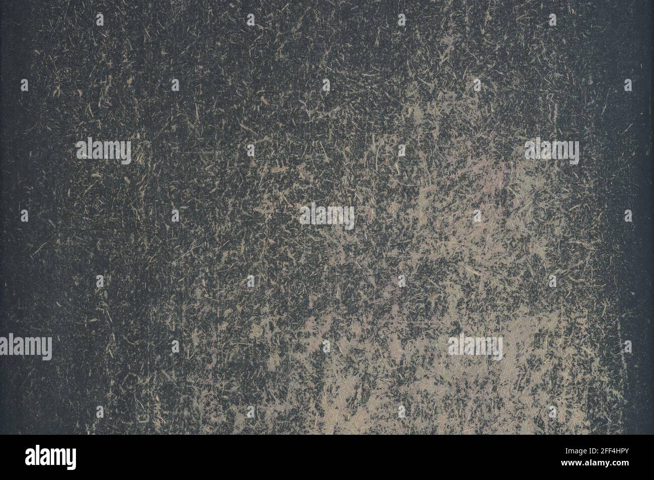 A worn drawing board with a rough surface with remnants of black paint ...