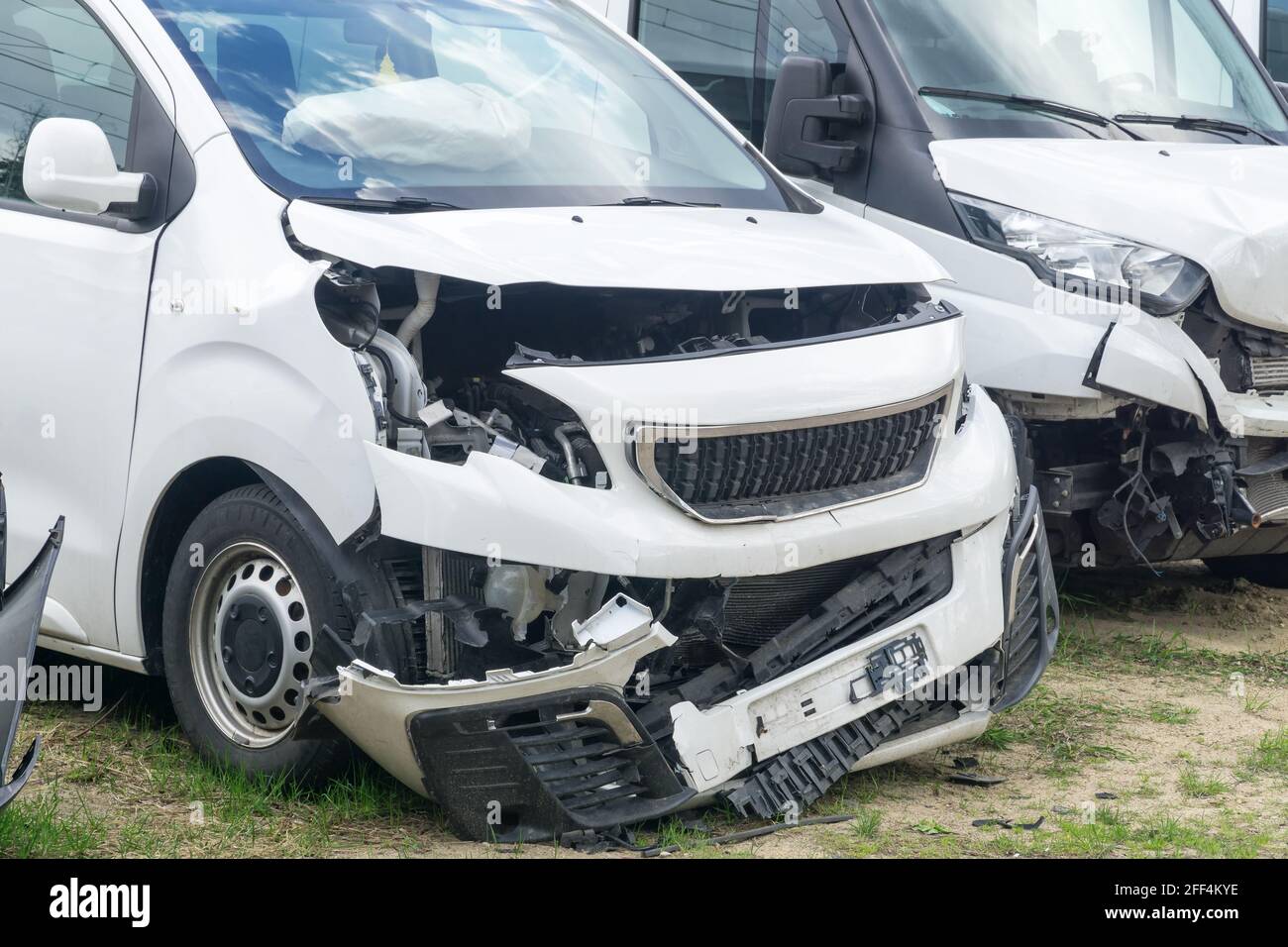 Two broken cars white vans after frontal collision Stock Photo - Alamy