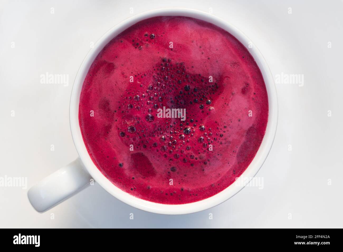 beet juice in white cup closeup top view Stock Photo - Alamy