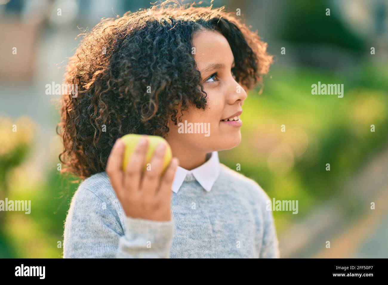 Adorable hispanic child girl smiling happy standing at the park Stock ...