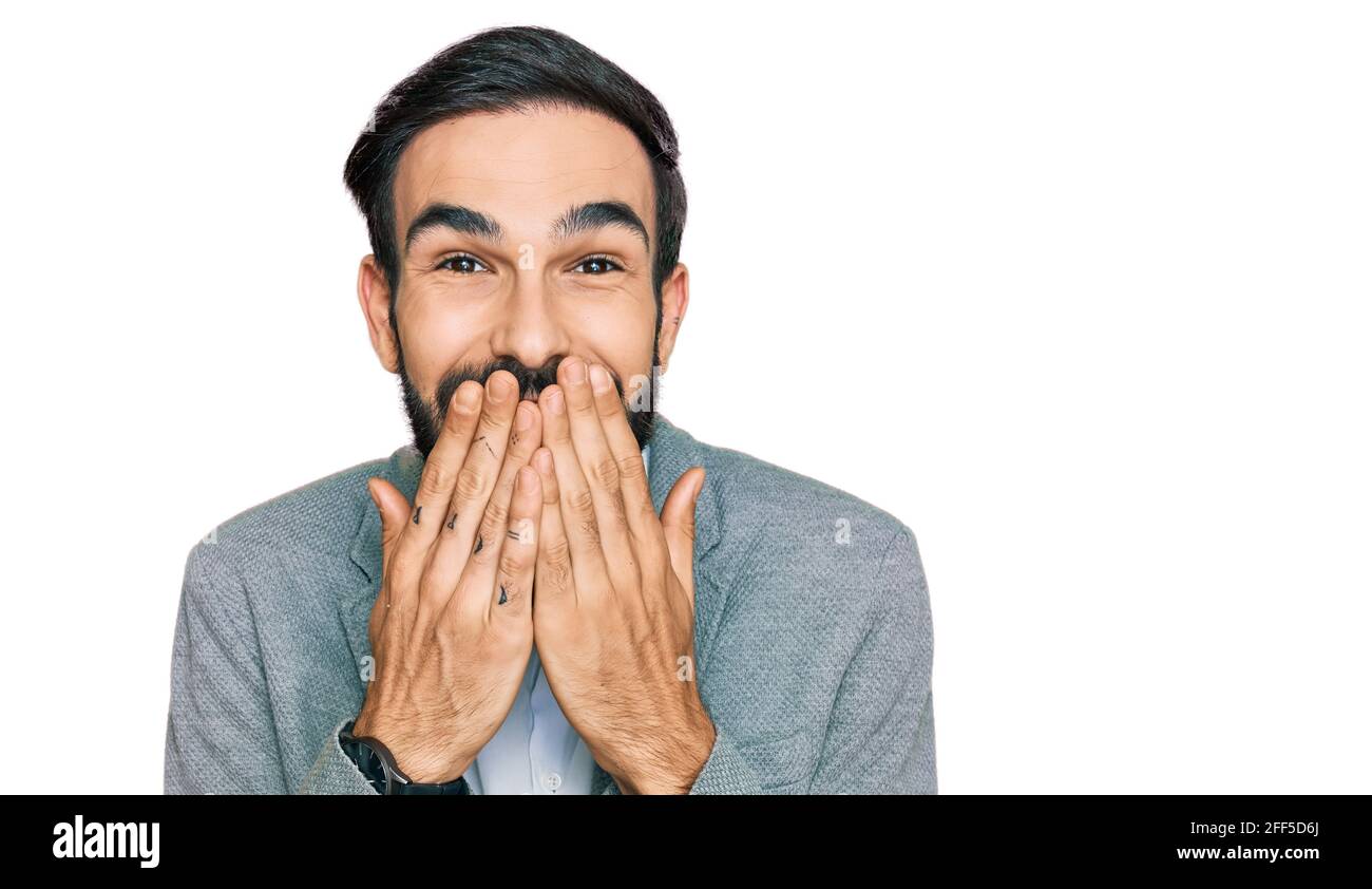 Young hispanic man wearing business clothes laughing and embarrassed ...