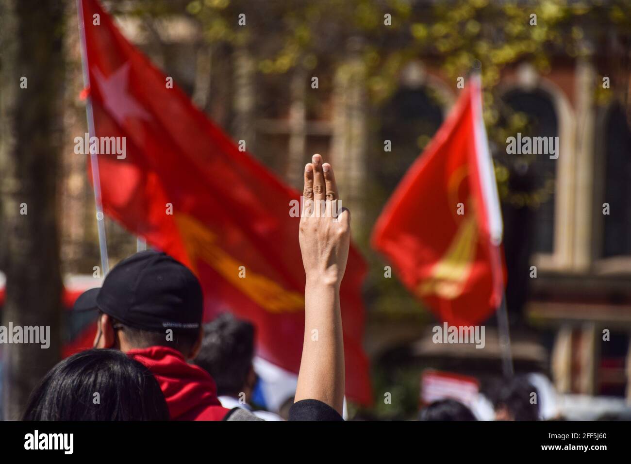 London, UK. 24th Apr, 2021. A protester holds up the three-finger ...