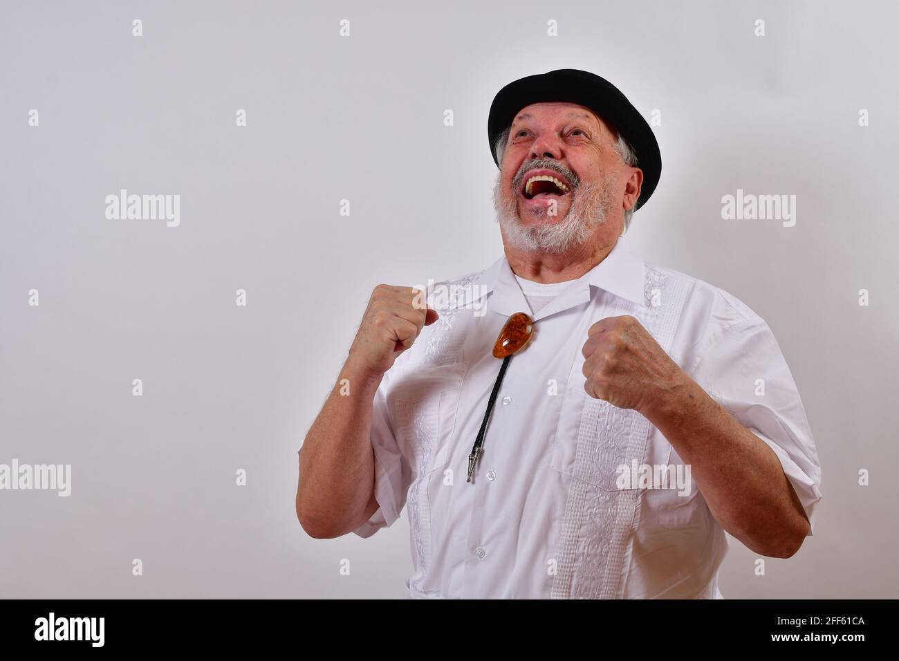 View of an elderly man happily laughing with gestures of hand fists on ...
