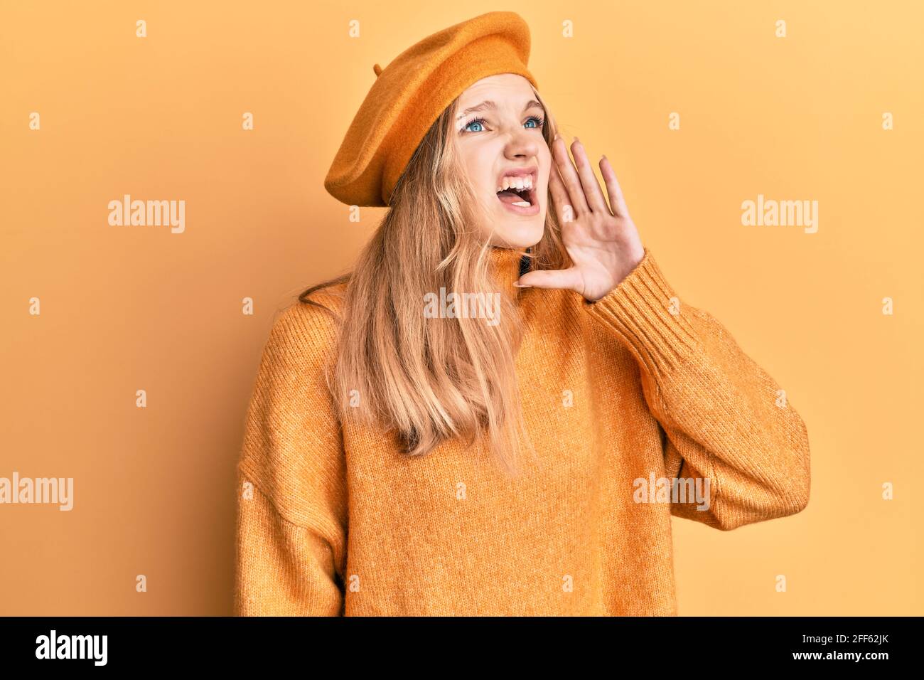 Beautiful young caucasian girl wearing french look with beret shouting ...