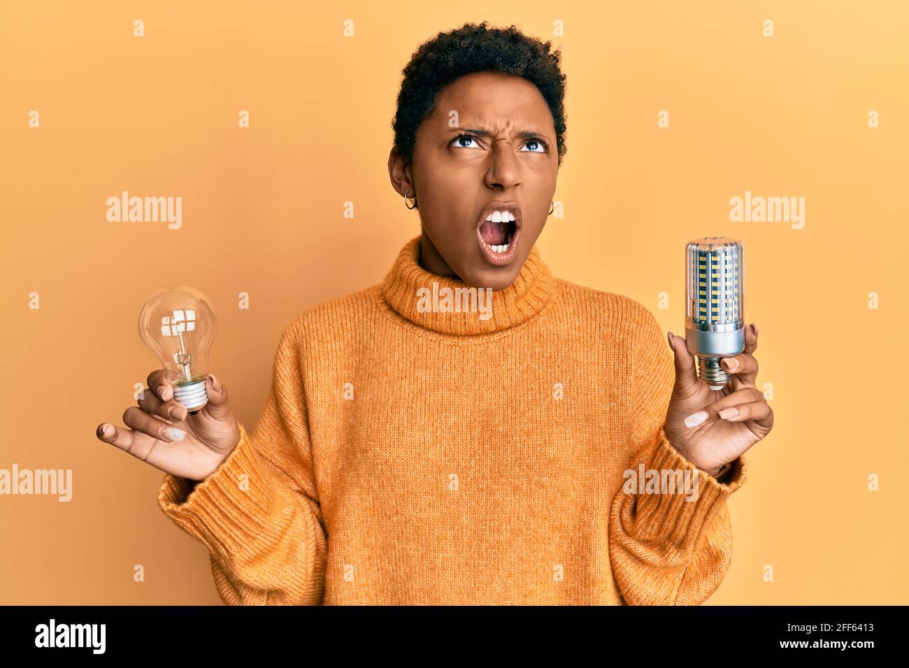 Young african american girl holding lightbulb for inspiration and idea ...