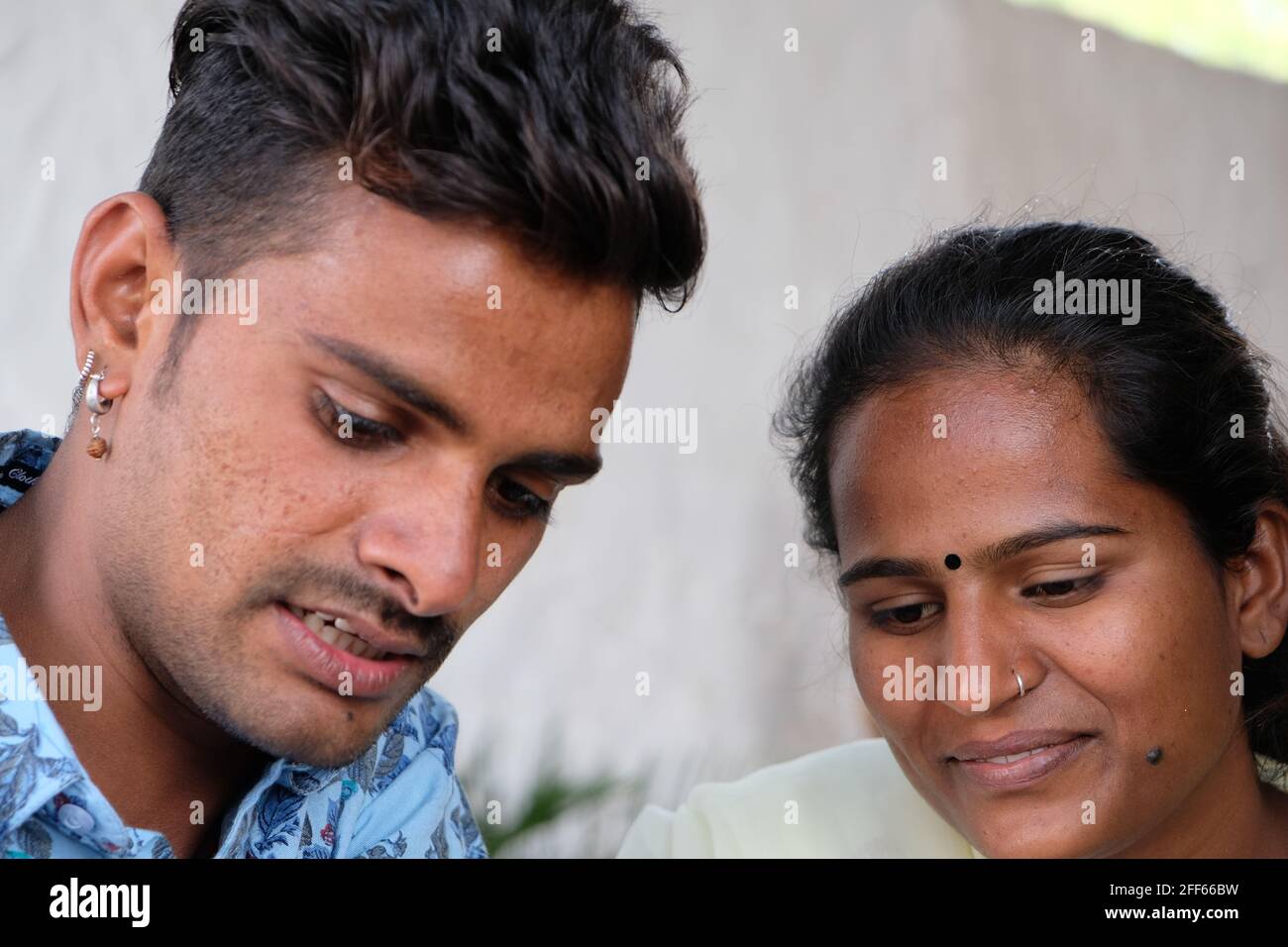 Couple of Indian young people concentrated watching something Stock ...