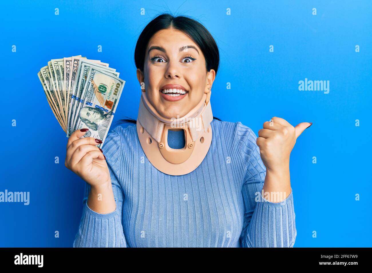 Beautiful brunette woman wearing cervical collar holding insurance ...