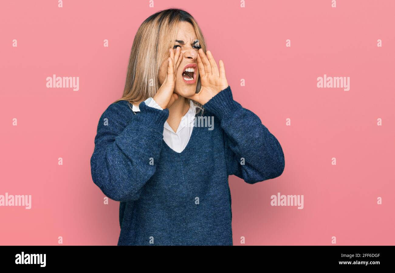 Young caucasian woman wearing casual clothes shouting angry out loud ...