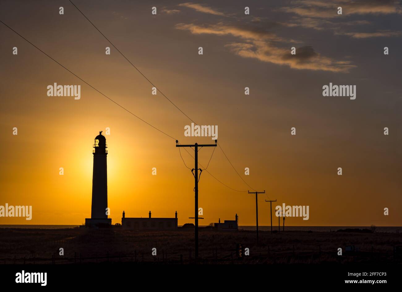 Barns Ness Lighthouse silhouetted at dawn sunrise with a colourful sky ...