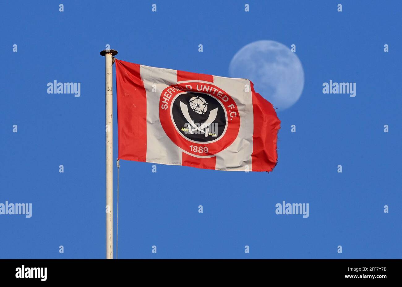 A view of the moon seen behind a Sheffield United flag on top of the ...