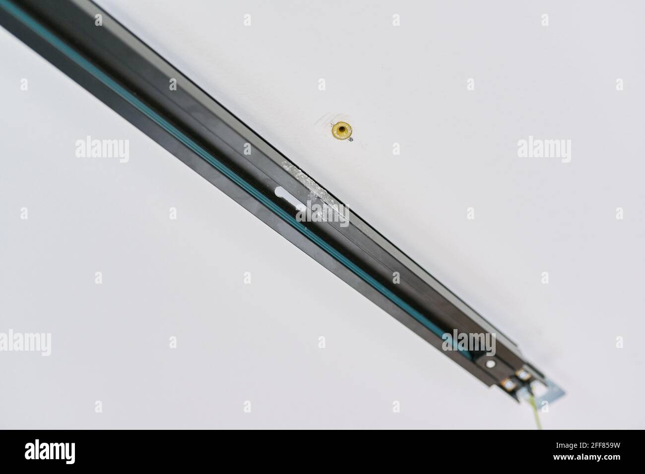 Installation of LED ceiling mounted modern track downlight Stock Photo ...