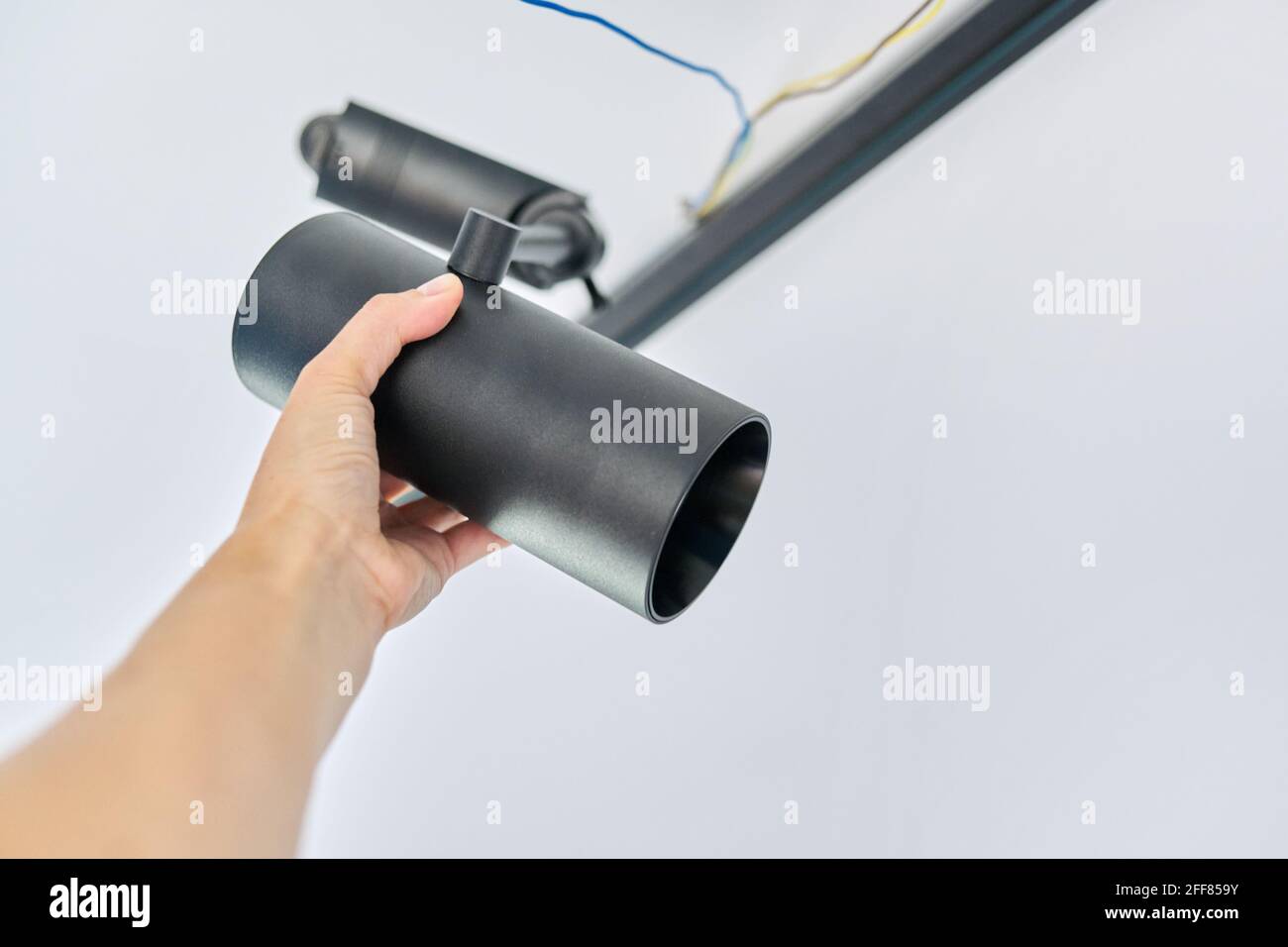 Installation of LED ceiling mounted modern track downlight Stock Photo ...