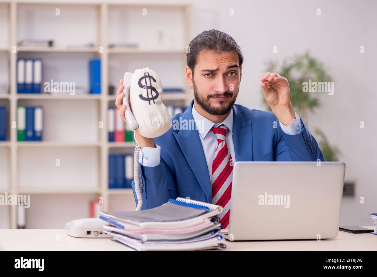 Young employee in remuneration concept Stock Photo - Alamy