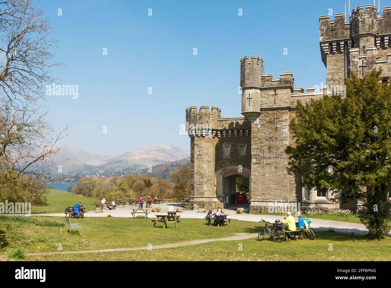 People sitting in the grounds of Wray Castle, Ambleside, Cumbria ...