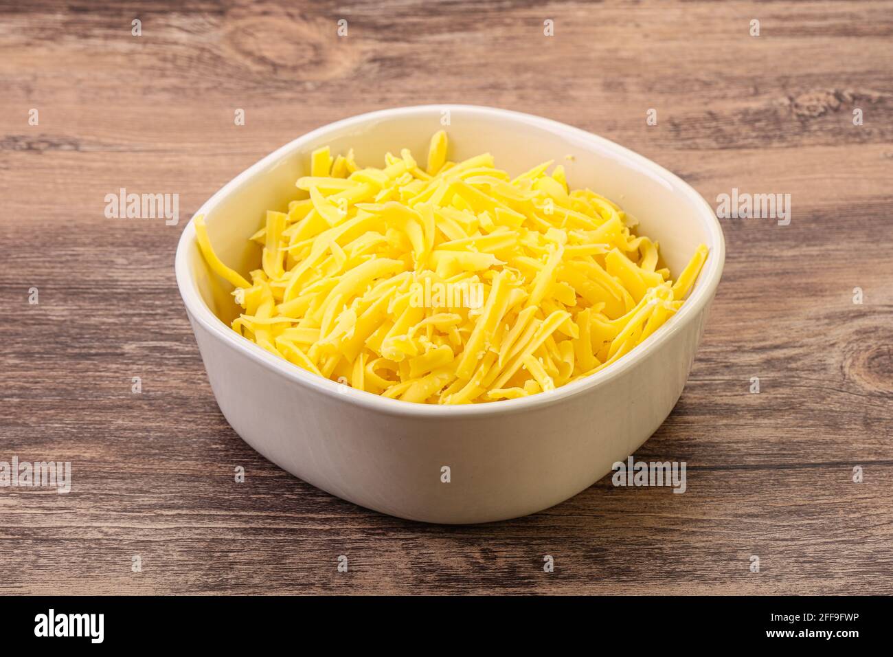 Shredded yellow cheese in the bowl for cooking Stock Photo - Alamy