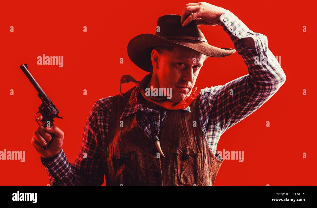 Portrait of man wearing cowboy hat, gun. Portrait of a cowboy. West ...