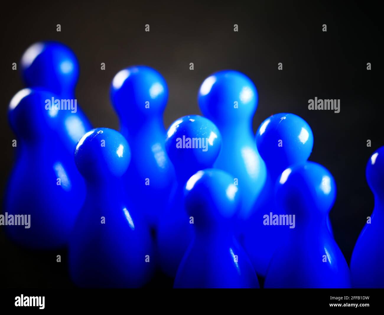 High angle shot of blue board game figures on a black surface Stock ...