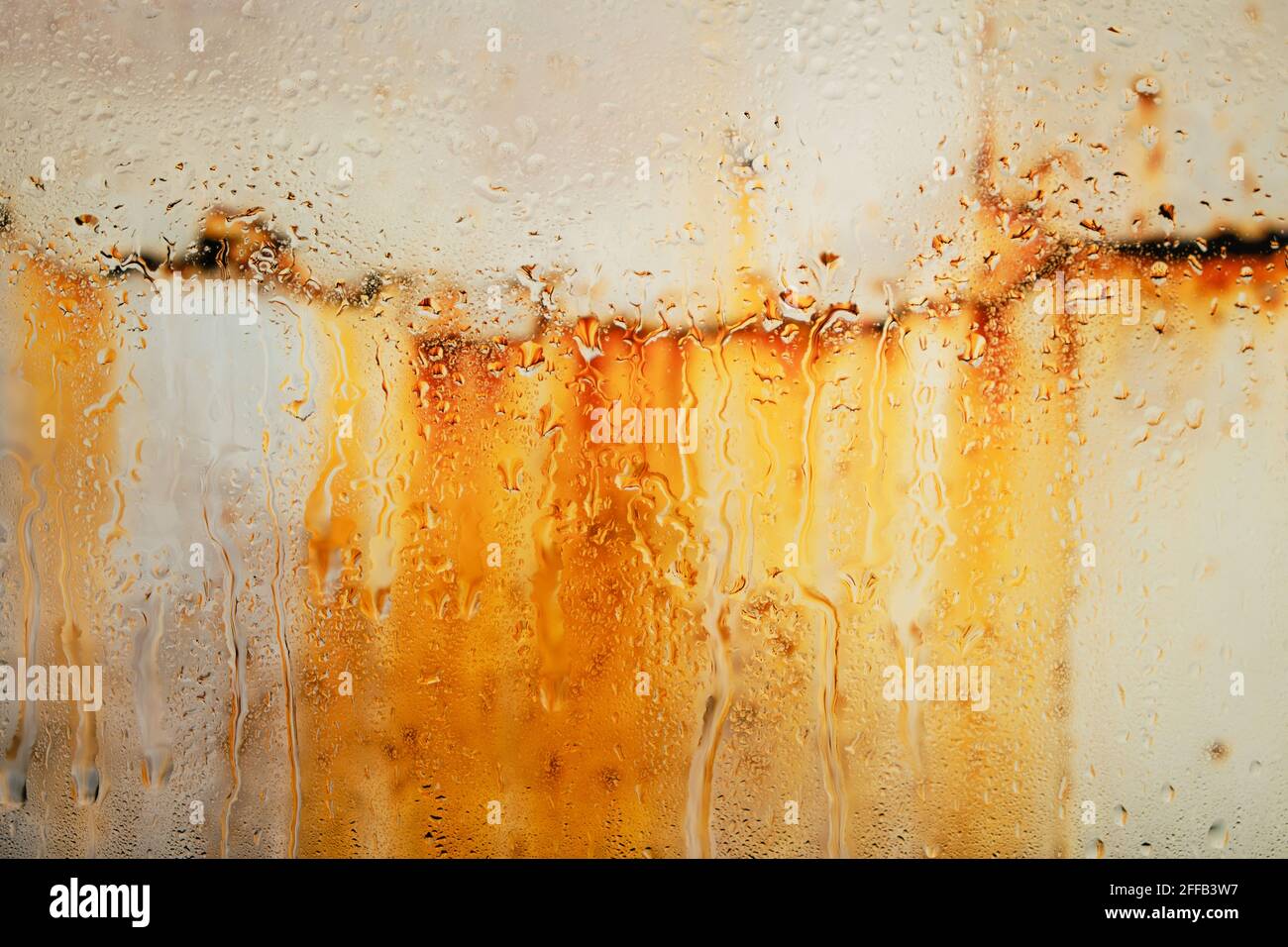 Streaks of rust on old metal behind dripping glass after rain Stock ...