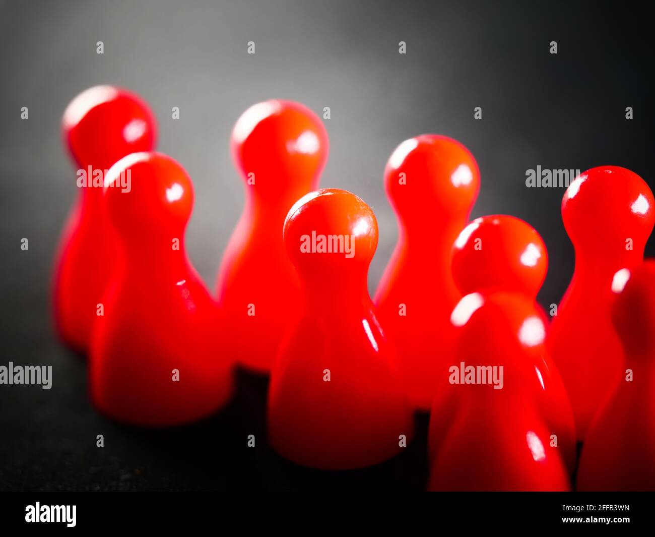High angle shot of red board game figures on a black surface Stock ...