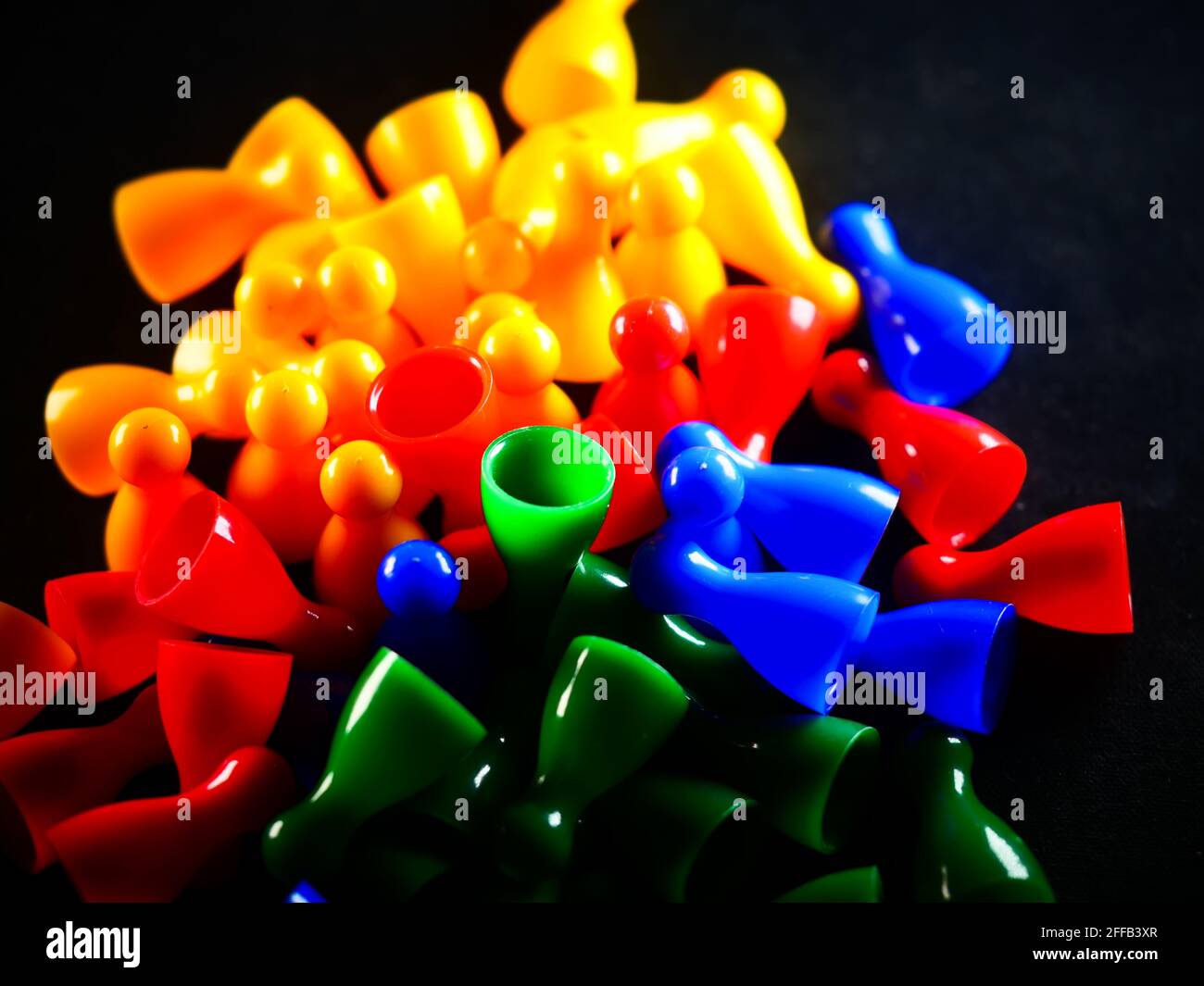 Closeup shot of colorful board game figures on a black surface Stock ...