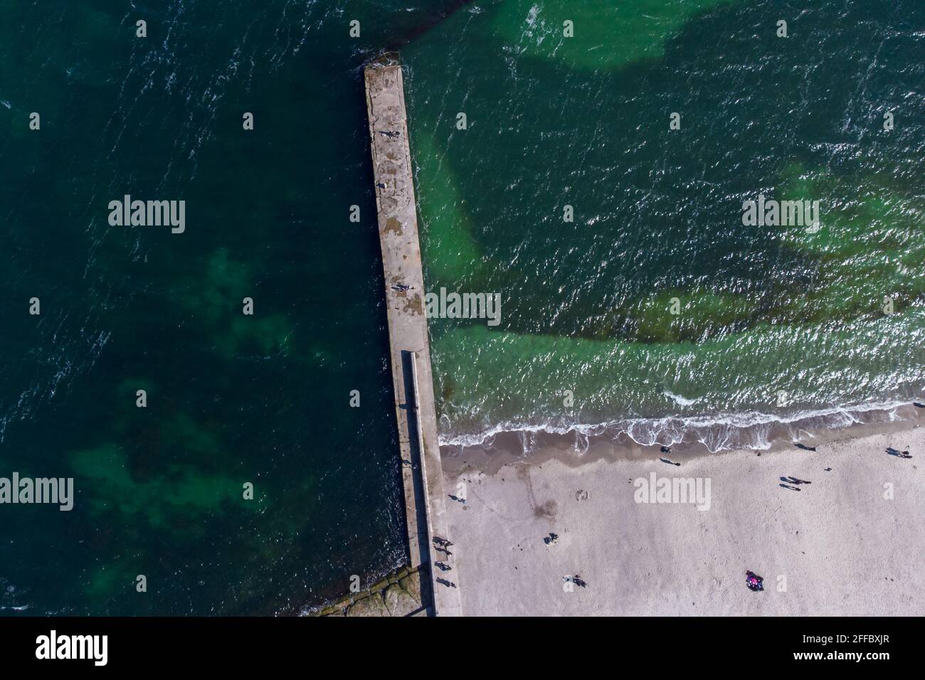 Sandy beach, concrete pier, clear sea water. Helicopter view Stock ...
