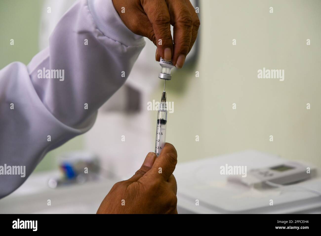 Nurse preparing a vaccine shot. Black woman hand with vial vaccine and ...