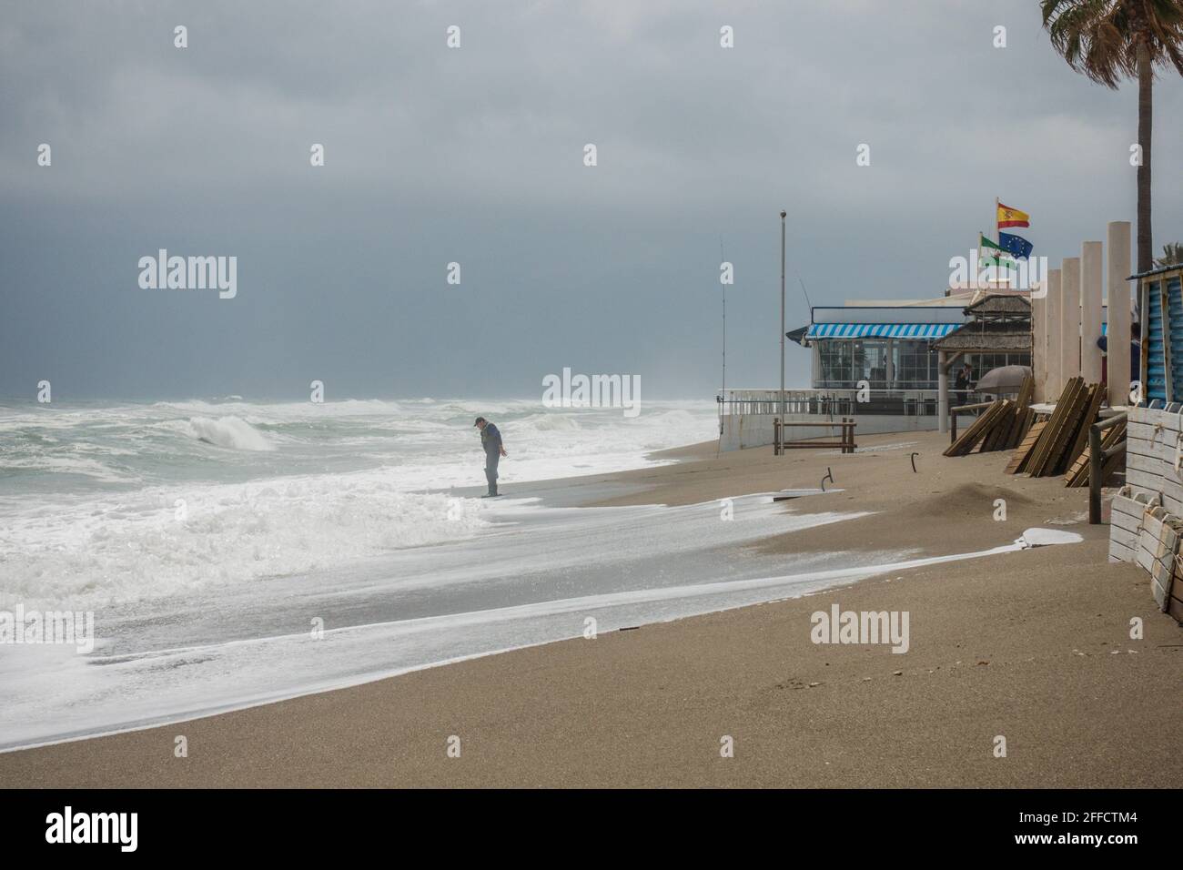 Rogue mediterranean sea, high tide with waves reaching beach bar ...