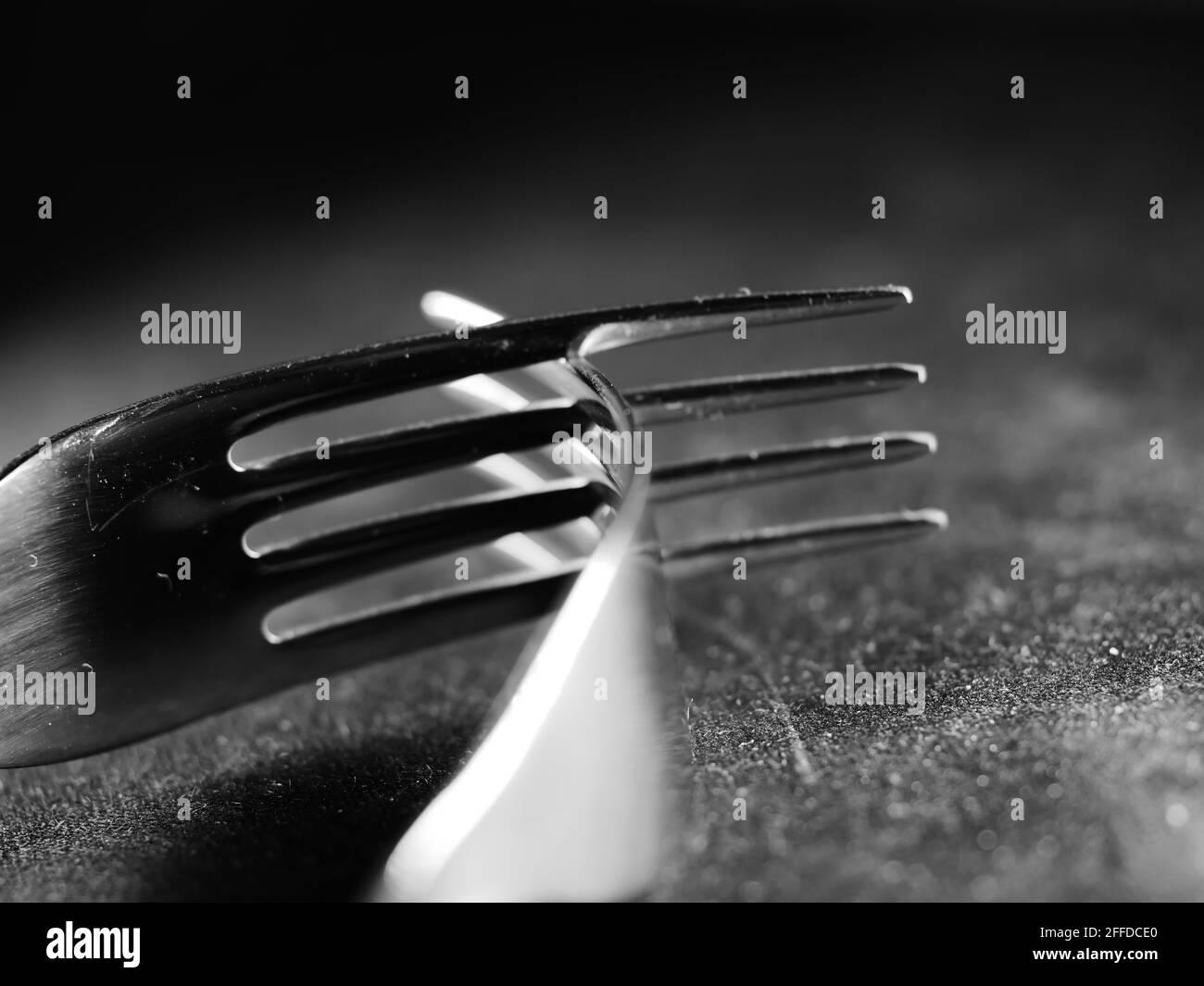 Closeup shot of two metal forks on a black fabric Stock Photo - Alamy