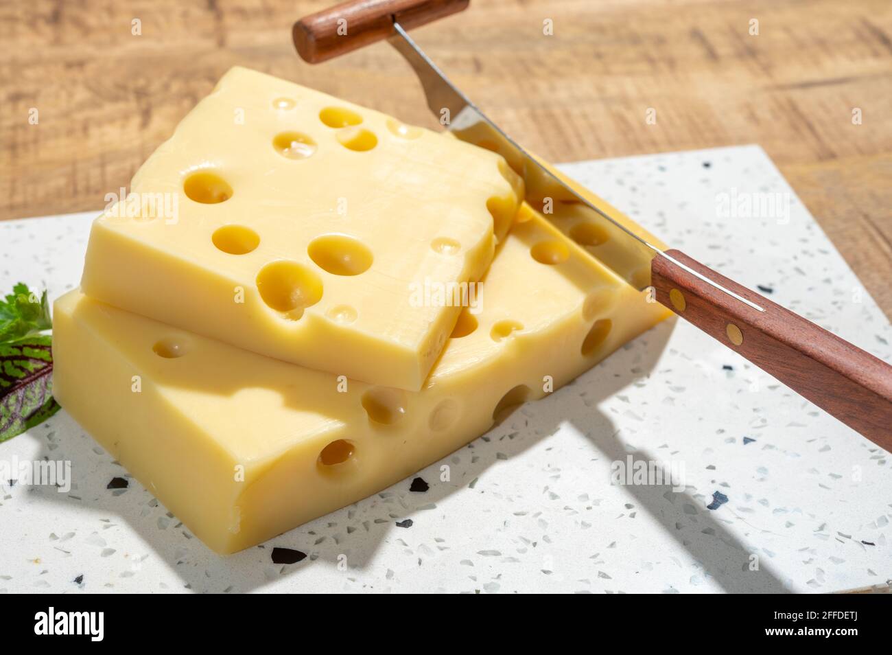 Cheese collection, blocks of French emmentaler cheese with many round ...