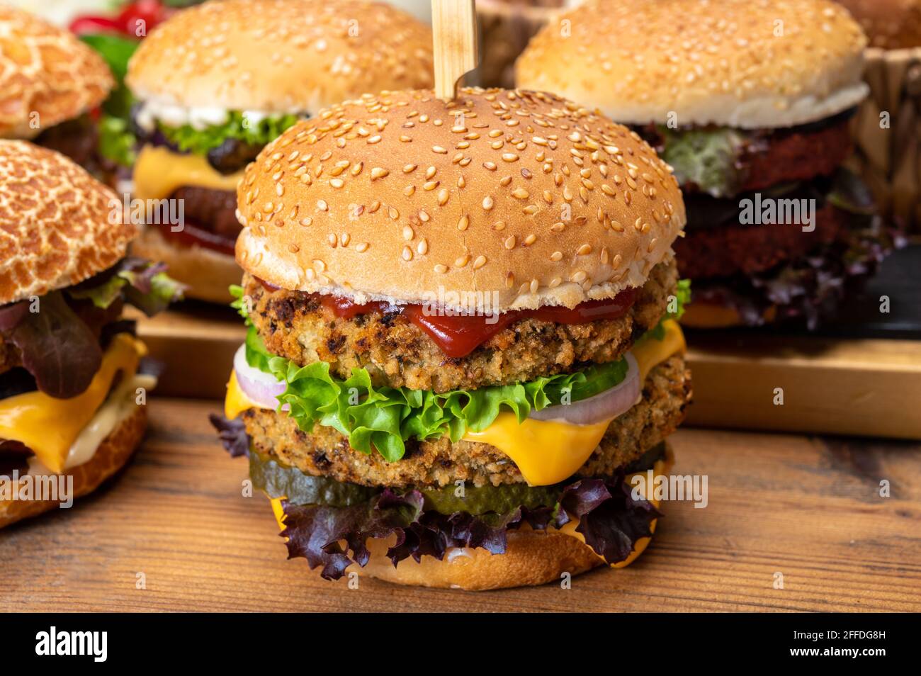 Tasty vegetarian cheeseburgers and hamburgers with round patties or ...