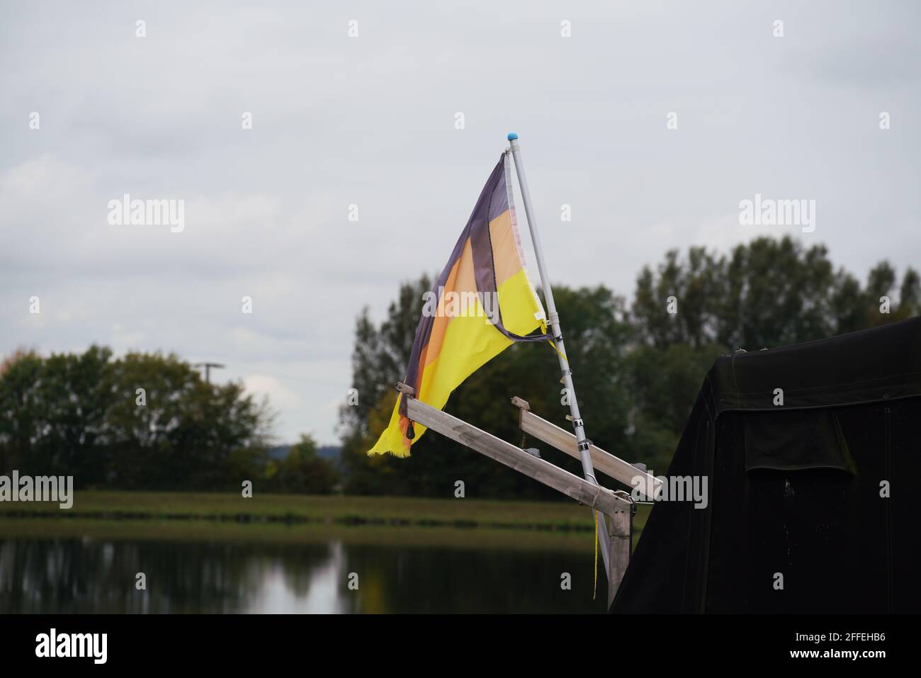 German flag hanging by the tent on the lake forest Stock Photo - Alamy