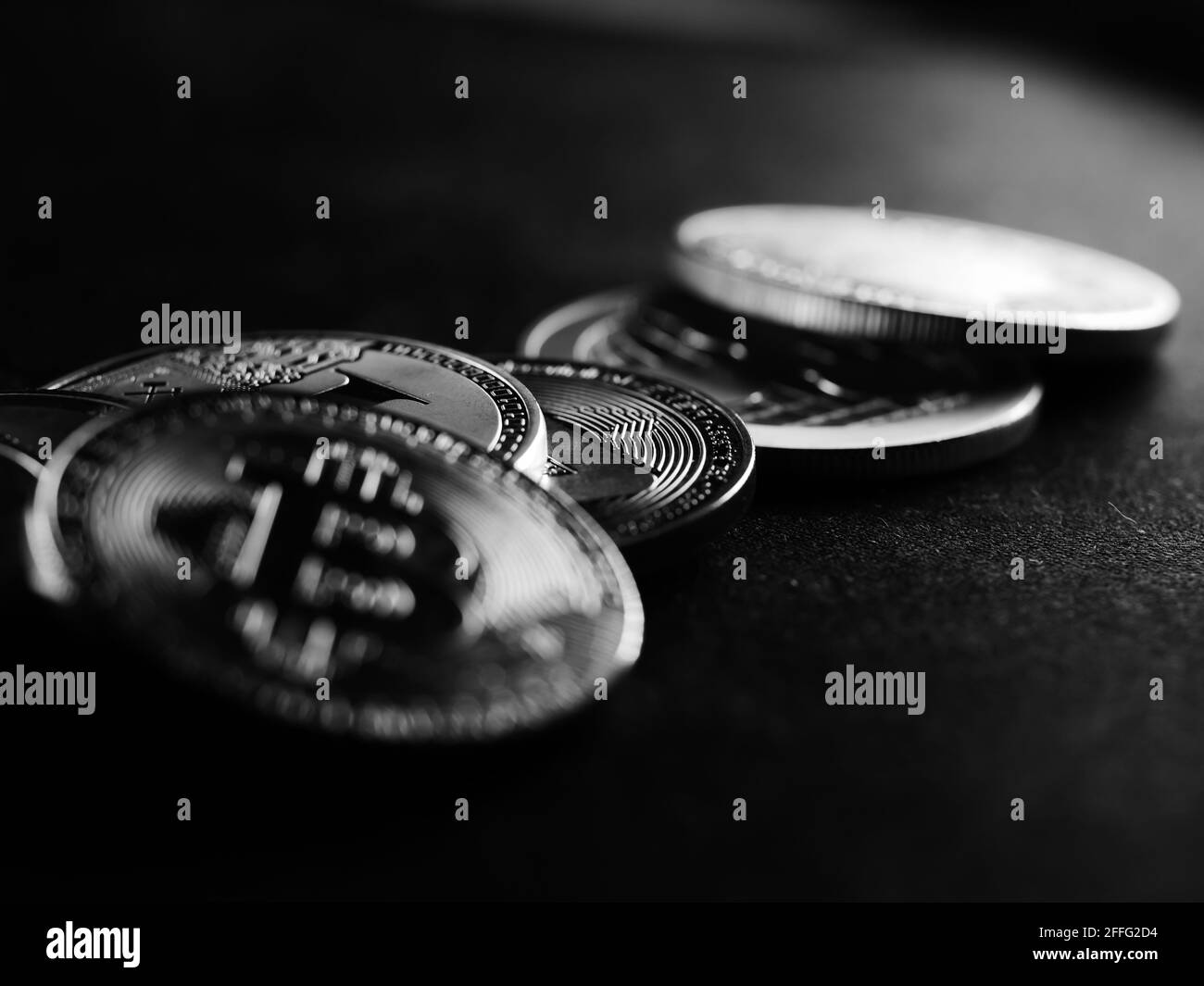 Grayscale shot of gold and silver crypto currencies Stock Photo - Alamy
